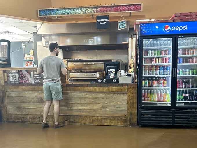 The ordering counter where brave souls step up to request pizzas that defy the laws of physics.