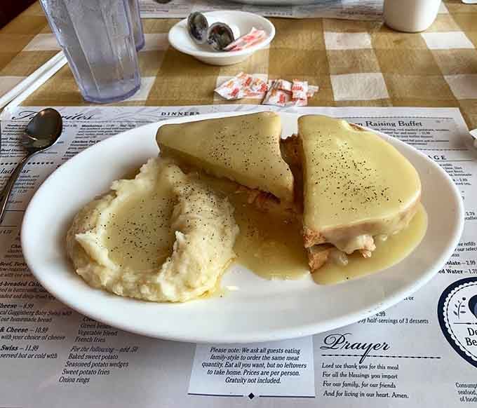 Hot turkey sandwich swimming in gravy, the kind of comfort food that gives hugs from the inside out.