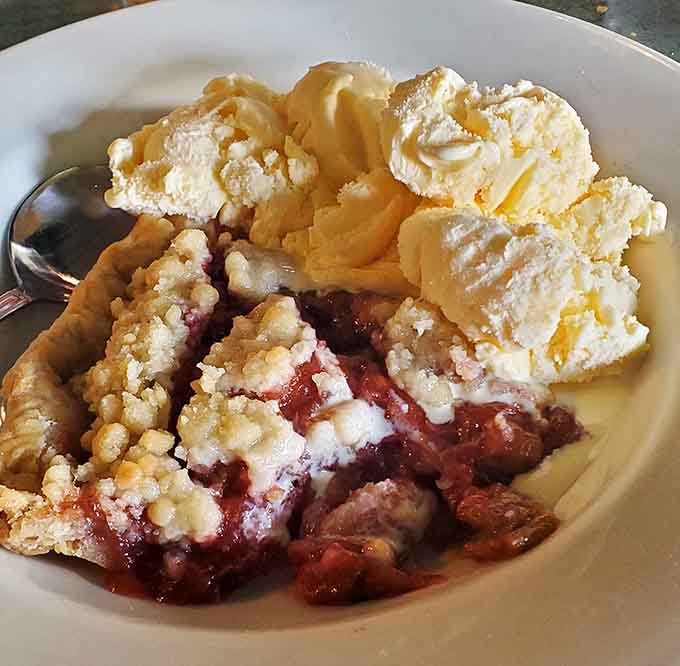 Warm berry pie topped with vanilla ice cream and whipped cream, because sometimes breakfast needs a sweet grand finale.