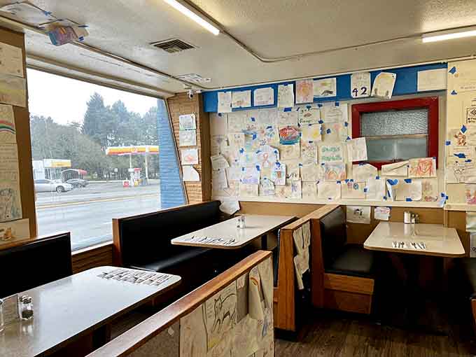 Booth seating with a view and walls decorated by decades of customers armed with crayons and creativity.