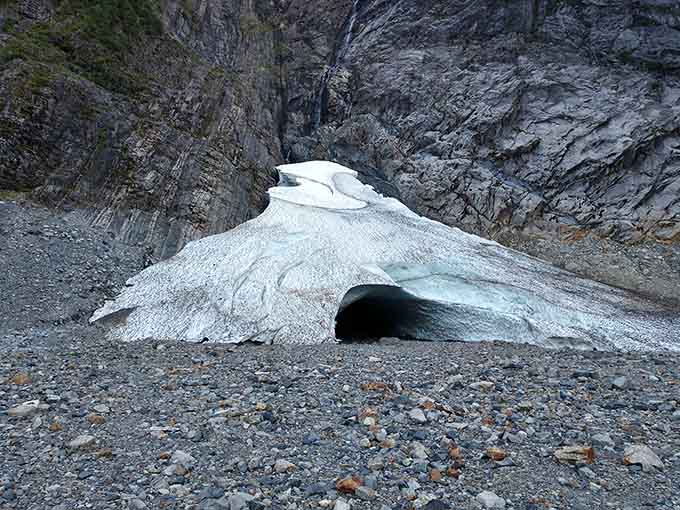 The cave entrance beckons like a frozen cathedral, beautiful and dangerous in equal, humbling measure.