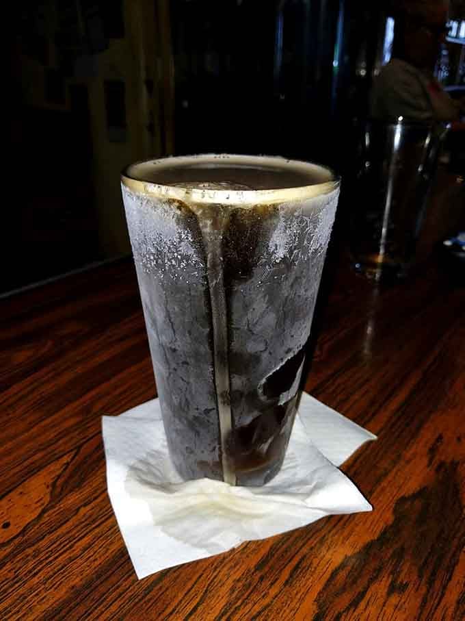 A frosty glass of dark ale that looks exactly like what you need after a long week of adulting.