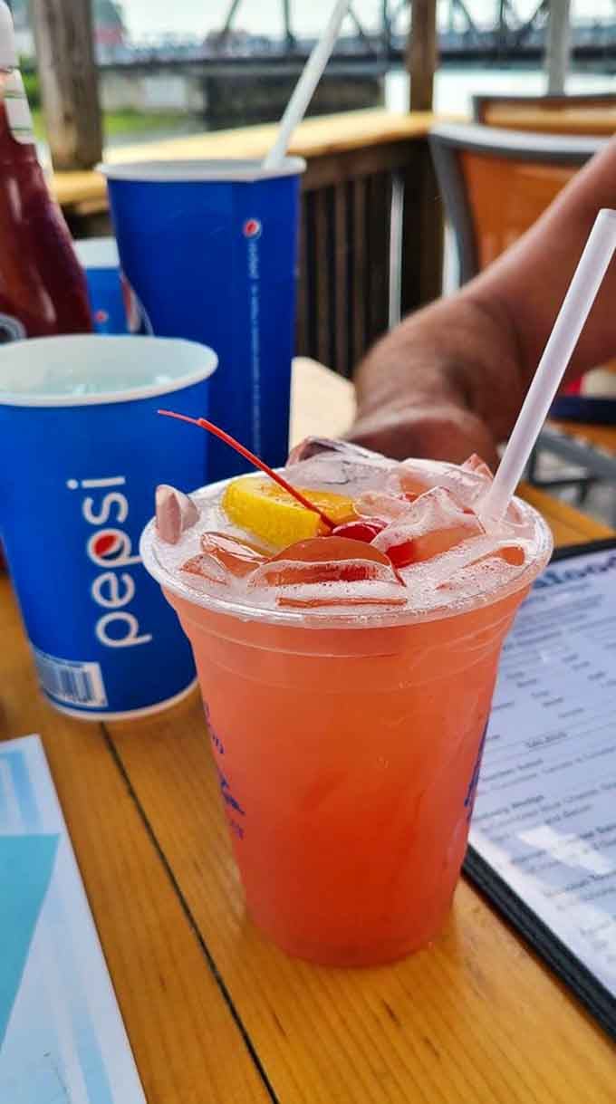 A Malibu Bay Breeze with fruit garnish transforms lunch into a mini vacation without the airport security hassle.