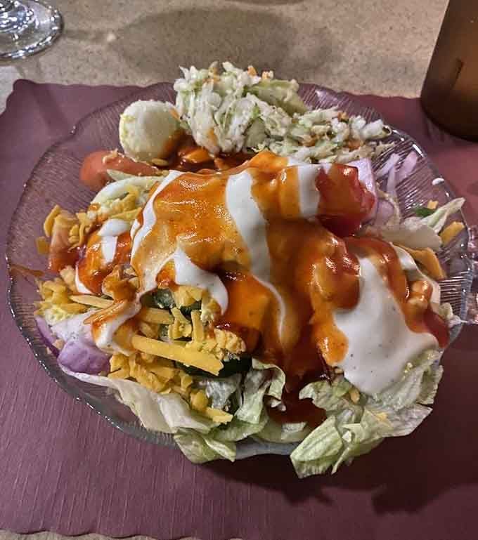 A salad bar creation topped with enough cheese and dressing to make nutritionists weep into their kale.