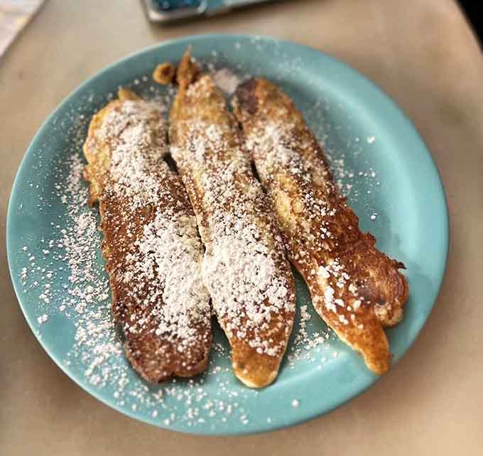 Bacon dippers dusted with powdered sugar, proving that sweet and savory together is always the right breakfast decision here.