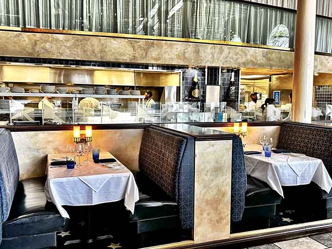 Booth seating with a view of the open kitchen means dinner comes with a side of culinary theater tonight.