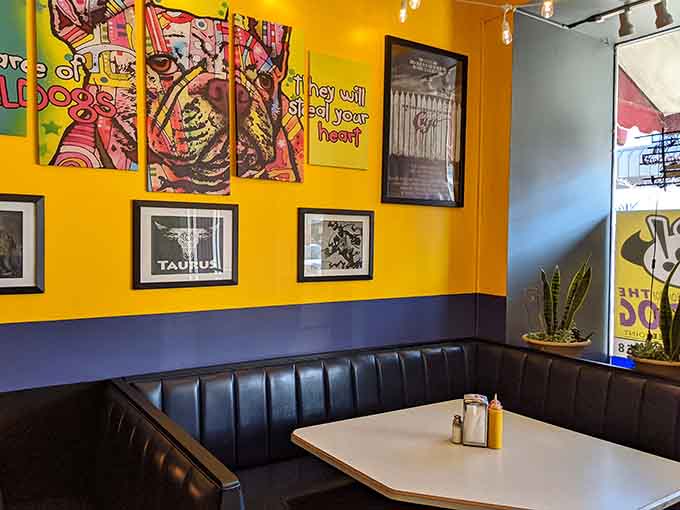Booth seating surrounded by comic art offers the perfect spot to settle in and enjoy your superhero-themed feast.