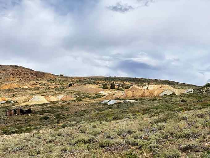The scarred hillsides reveal where miners tore into the earth, leaving colorful geological wounds that still haven't healed after decades.