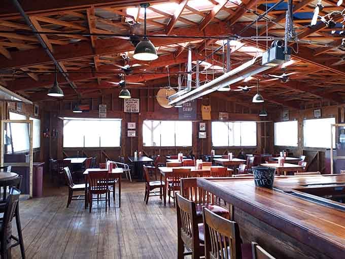 Exposed beams, pendant lights, and windows that let the outside in, creating an atmosphere that's equal parts fishing shack and waterfront paradise.