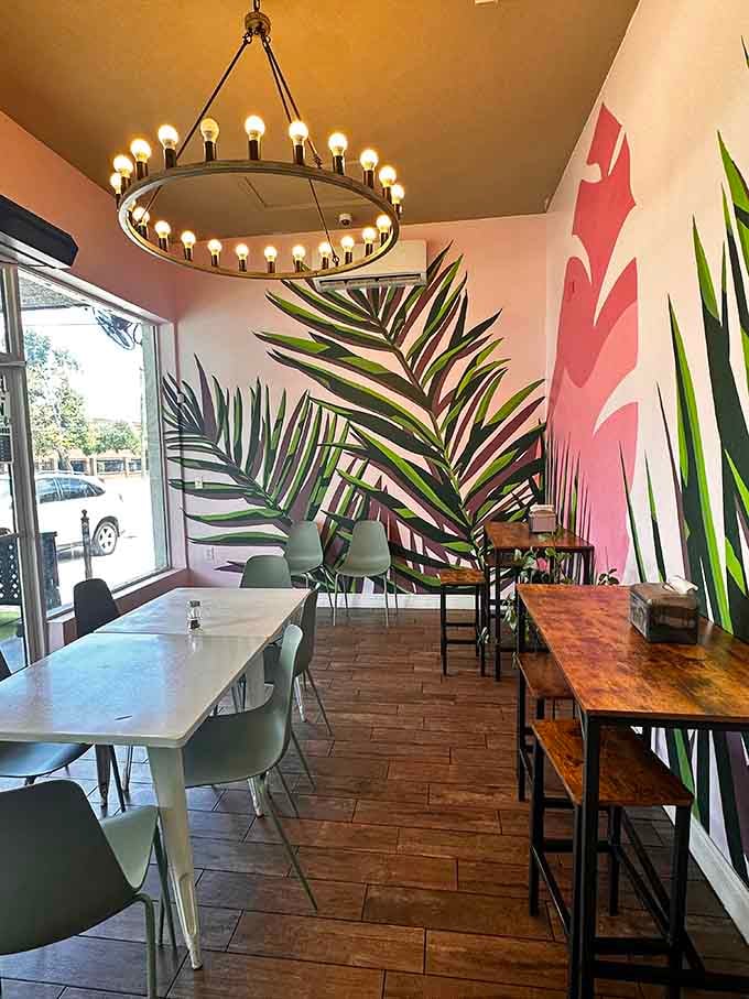 Palm leaf murals and mismatched seating create that "I'm too cool to try this hard" vibe that somehow works perfectly.