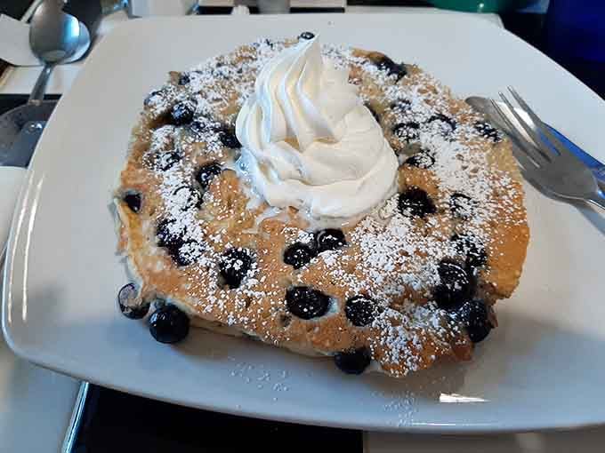 Blueberry pancakes dusted with powdered sugar and crowned with whipped cream belong in a breakfast hall of fame.