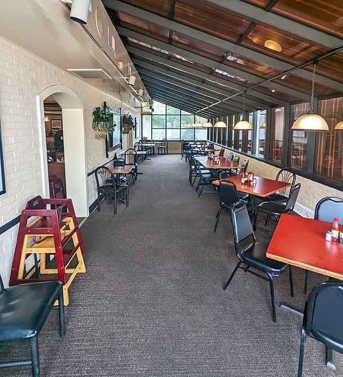 The patio dining area offers extra seating with white brick walls and plenty of natural light streaming in.