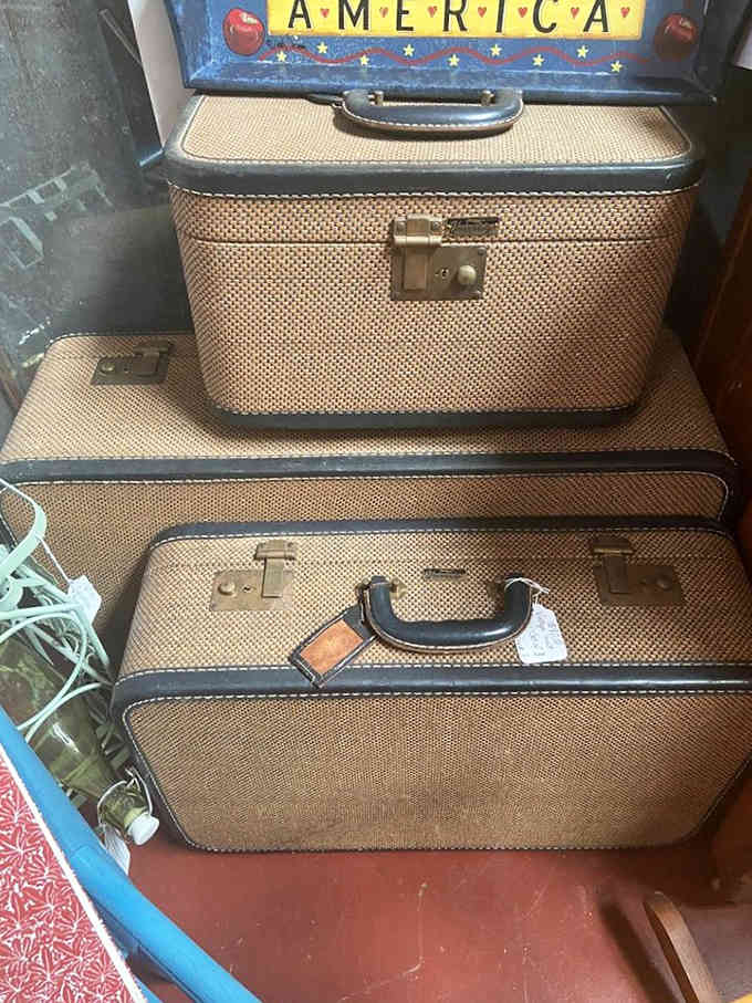 Stacked vintage suitcases ready for adventures, though they've clearly already seen more than most modern luggage ever will.