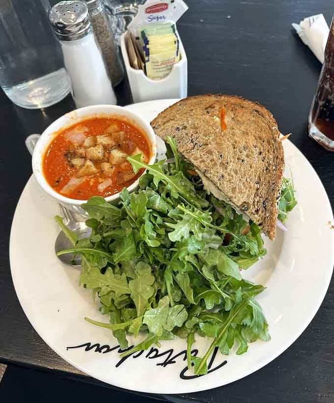 Tomato artichoke soup paired with arugula and crusty bread proves lunch can be both virtuous and utterly soul-satisfying simultaneously.