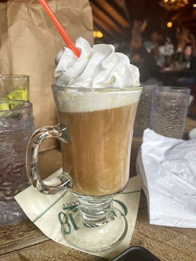The Spanish coffee arrives with whipped cream piled so high it defies both gravity and reasonable expectations for a beverage.