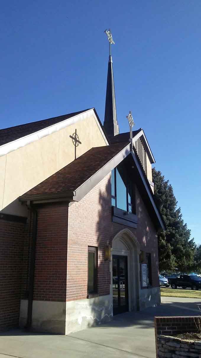 Church steeples reach skyward against blue Colorado skies, architectural grace notes in the town's visual symphony of faith.