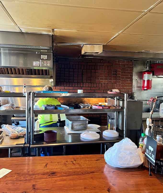 A peek behind the curtain reveals the brick pit where all that smoky magic actually happens daily.