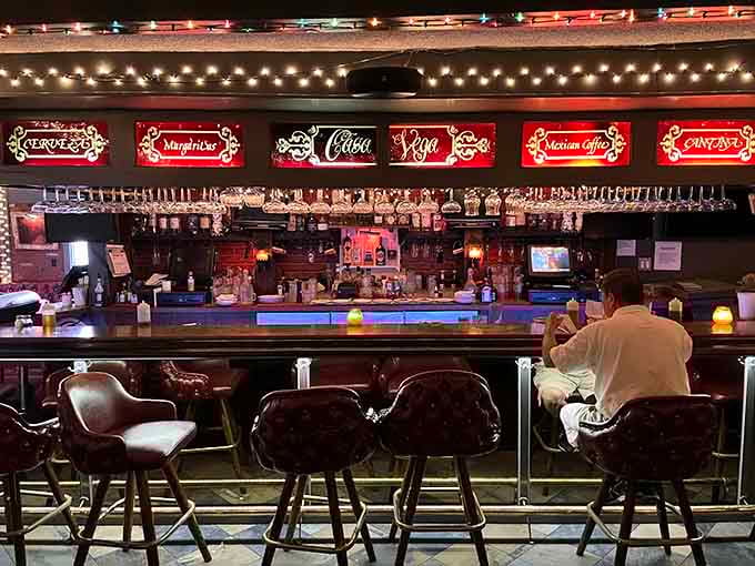 The bar stretches out like an invitation, with bottles gleaming and bartenders ready to work their magic.