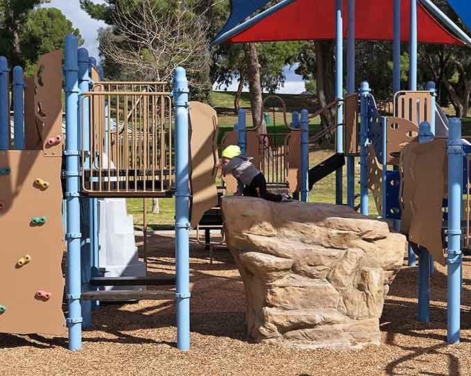The playground equipment promises tired kids and happy parents, which is basically the definition of a successful family outing.