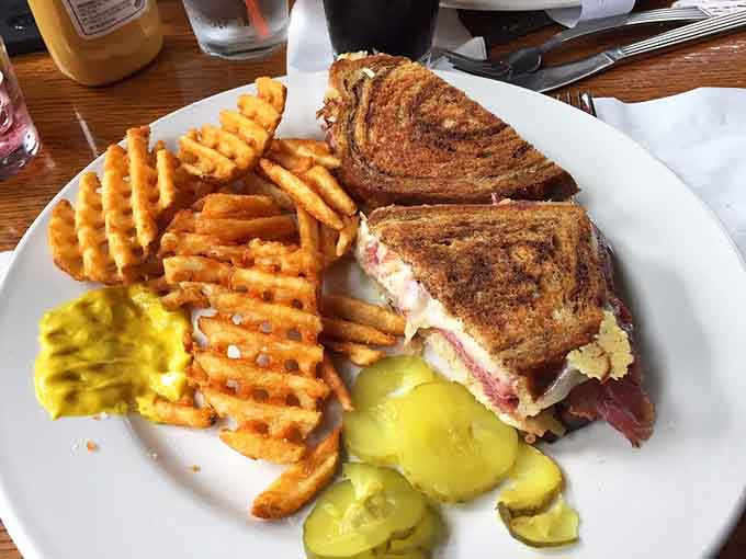 A Reuben sandwich with waffle fries proves that classic deli meets quirky train restaurant equals pure deliciousness.