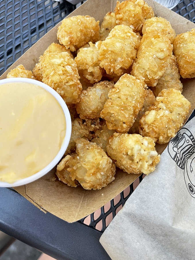 Golden tater tots with a side of cheese sauce, because sometimes childhood knew exactly what it was doing.