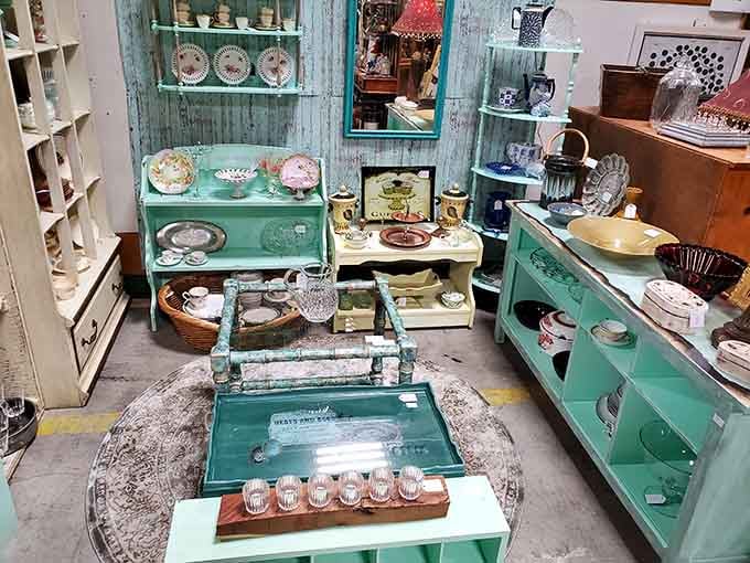 That turquoise hutch is giving serious shabby chic vibes, loaded with dishes that survived decades of Sunday dinners and family gatherings.