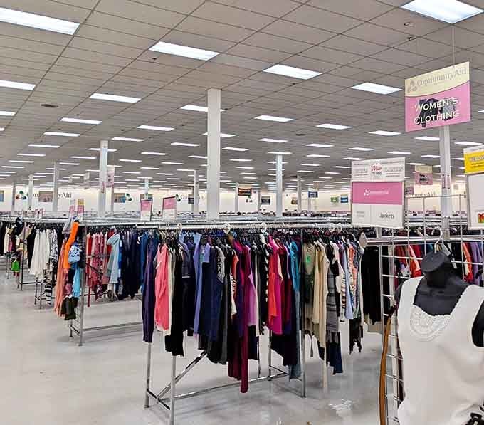 Women's clothing racks stretching toward the horizon, color-coded and organized better than some department stores you've visited.