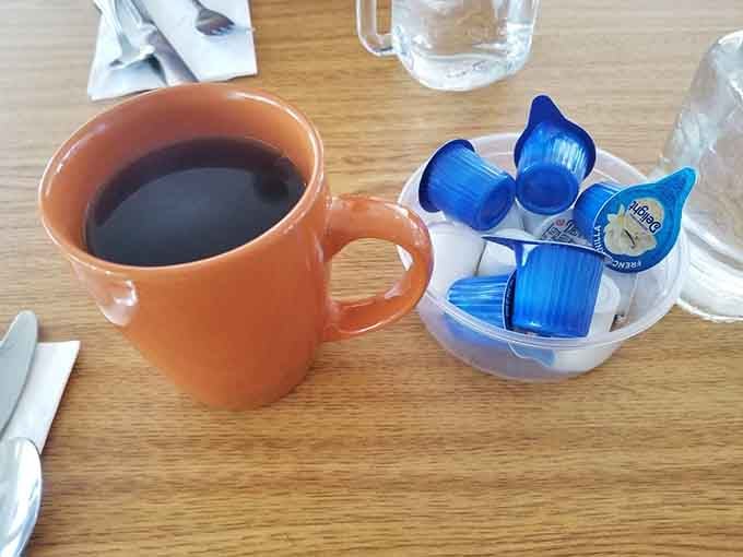 Simple orange mug, strong black coffee, the kind of no-nonsense morning fuel that built this country.