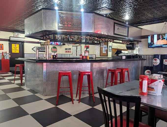 The bar area gleams with chrome and possibility, where red stools invite you to sit and stay awhile.