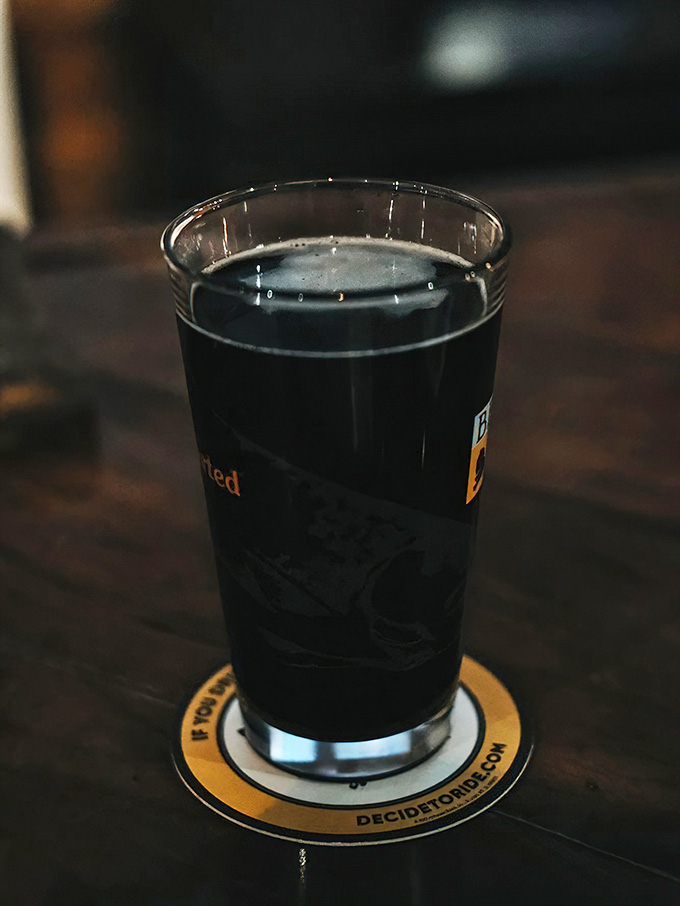 Dark stout in a branded glass on a coaster shows they take their beer selection seriously here.