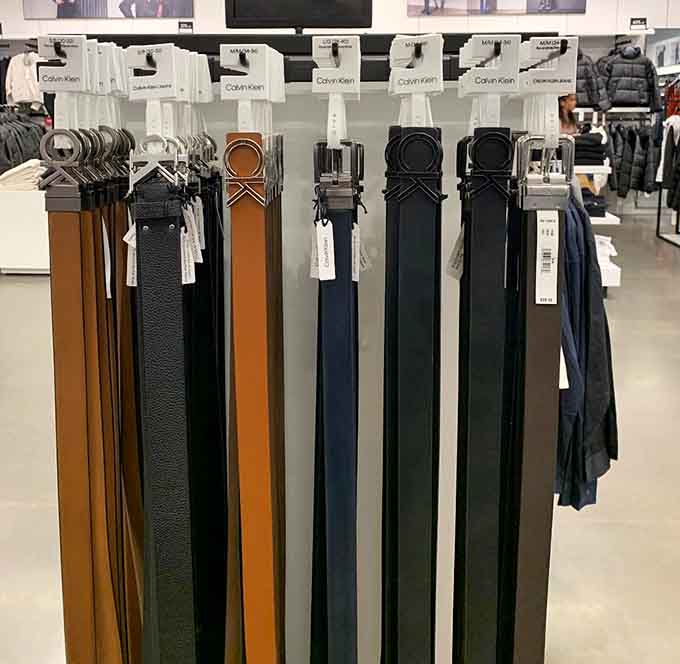 Belts hanging like leather rainbows, ready to hold up pants and pull together any outfit instantly.