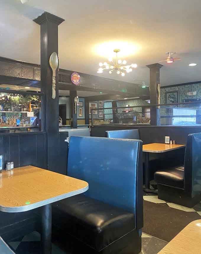 More turquoise booths stretching into the distance, each one holding decades of conversations, laughter, and satisfied sighs after great meals.