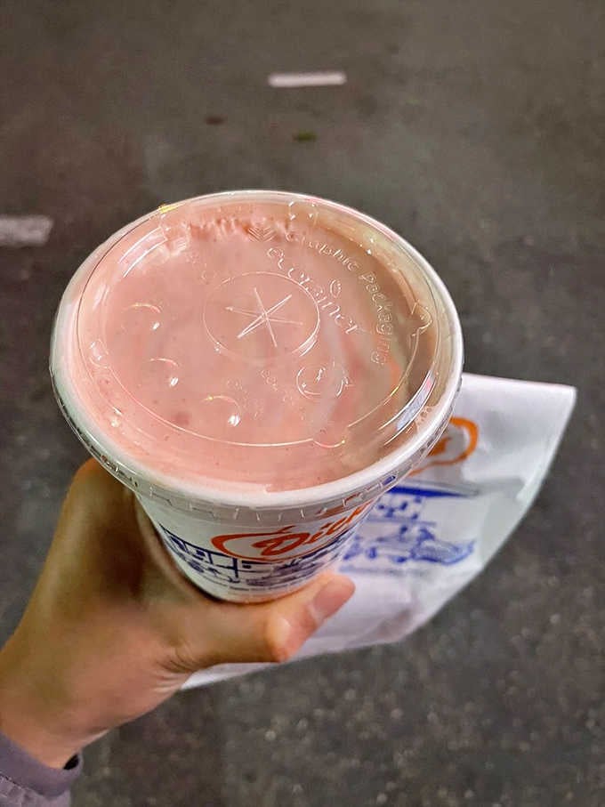 That strawberry shake is thick enough to require actual effort, which means it's doing everything right.