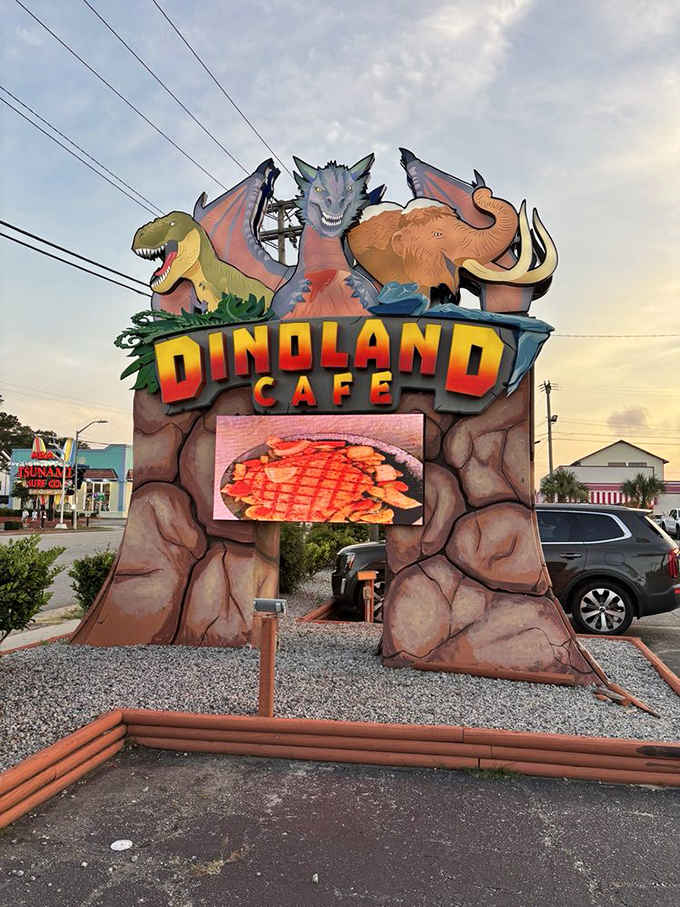 The towering sign features dinosaurs holding court over a digital menu board, impossible to miss from the road ahead.