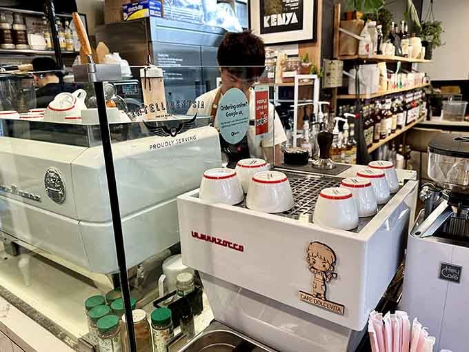 Behind the espresso machine where the magic happens, one perfectly crafted drink at a time with genuine care.