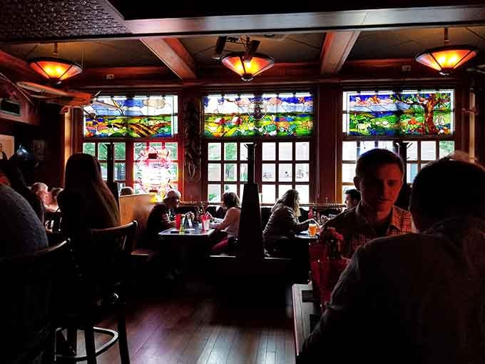 Stained glass windows and warm lighting create an ambiance that makes every meal feel like a special occasion.