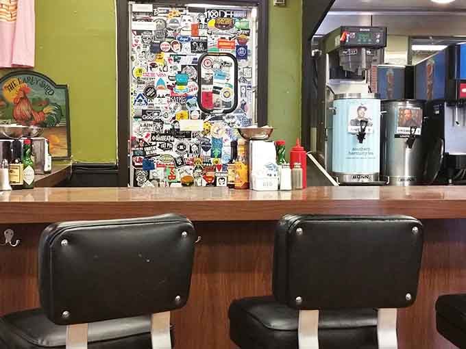 Counter seating with a view of stickers and memories, where solo diners can enjoy their meal without feeling like they're eating alone.