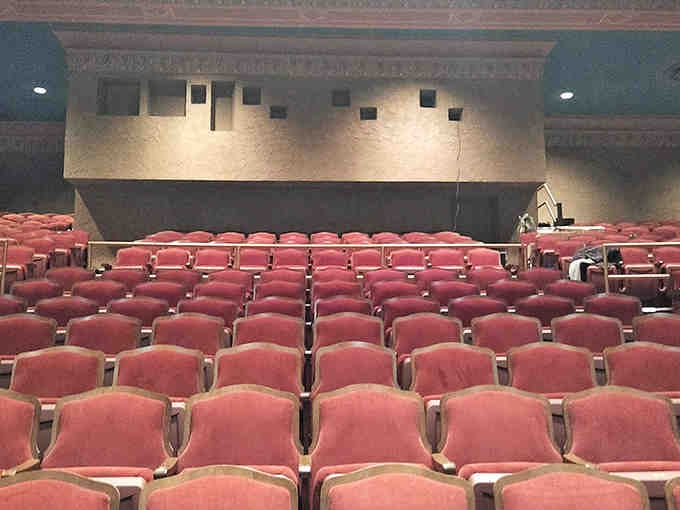 Rows of burgundy seats face a stage where vaudeville once ruled and concerts now reign.