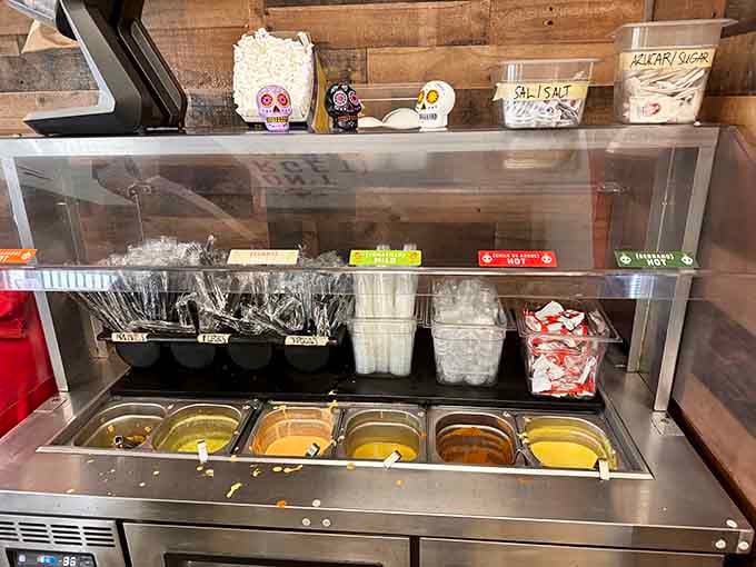 Fresh salsas in squeeze bottles and utensils at the ready: this self-serve station is your ticket to customized perfection.