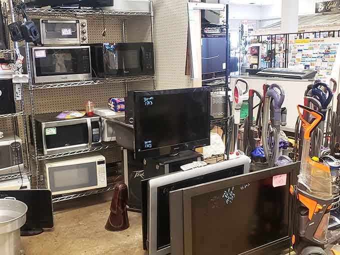 Microwaves stacked like they're auditioning for an appliance talent show, each one ready for its forever home.