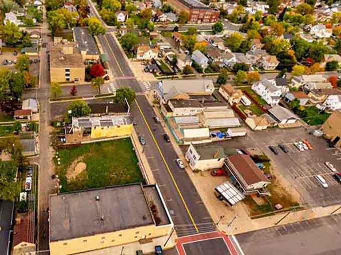 Aerial views reveal a town nestled perfectly between forests and history, small but mighty in character.