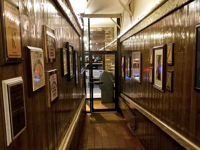 Framed memories line the hallway walls, turning a simple walk to your table into a journey through decades of community history.