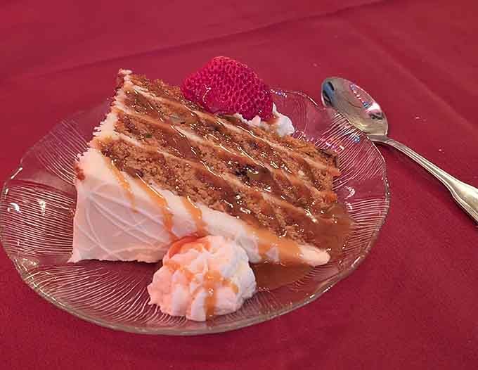 Layers of carrot cake that look like they were engineered by someone who understands that life's too short for small desserts.