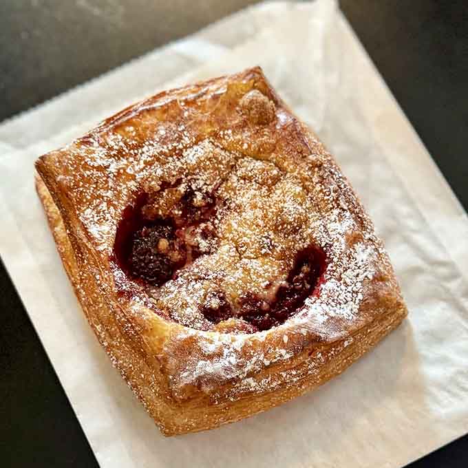 Golden pastry dusted with powdered sugar and filled with fruit; dessert here takes the sweet route without any turbulence.