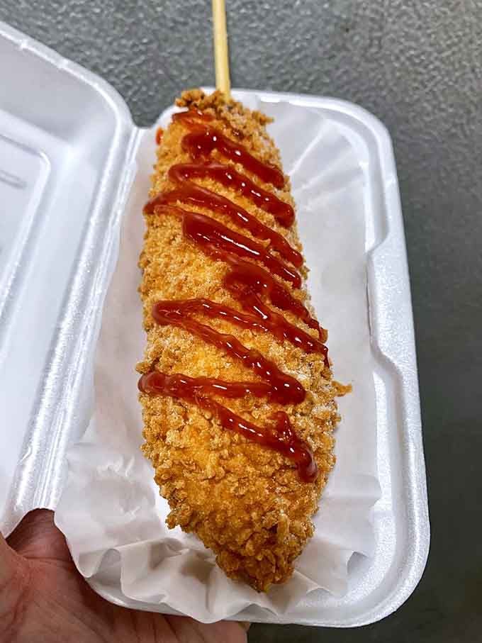 Korean corn dog with panko crust and ketchup stripes, where East meets West on a stick with spectacular results.