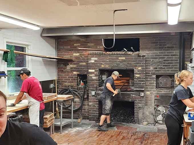 The coal-fired ovens in action, where temperatures soar and pizza dreams become deliciously charred reality every single day.