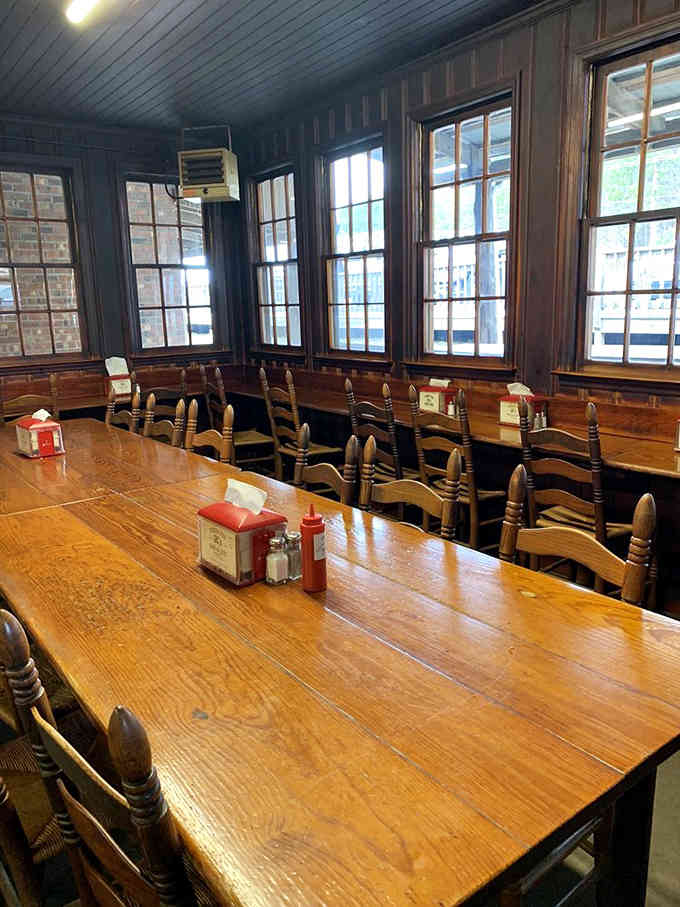 Natural light streaming through vintage windows, illuminating tables that have hosted countless family gatherings and first dates.