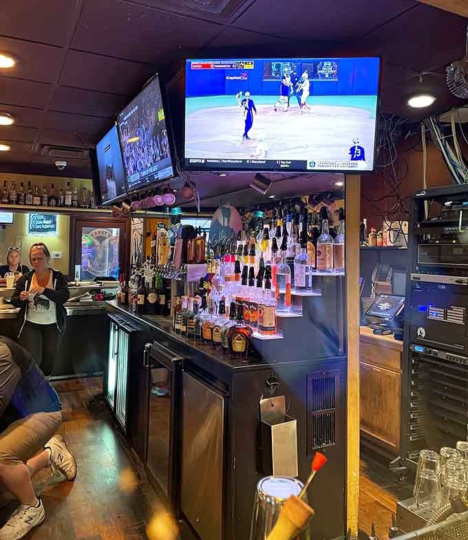 The bar area features enough screens and bottles to keep everyone happy, regardless of their beverage preferences.