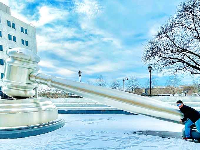 Nothing says "great vacation photo" quite like pretending to lift a gavel that weighs more than your car.