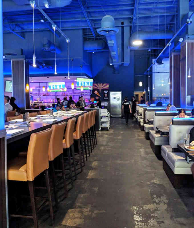 Spacious seating and dramatic blue lighting create an atmosphere that's part nightclub, part culinary playground for grown-ups everywhere.